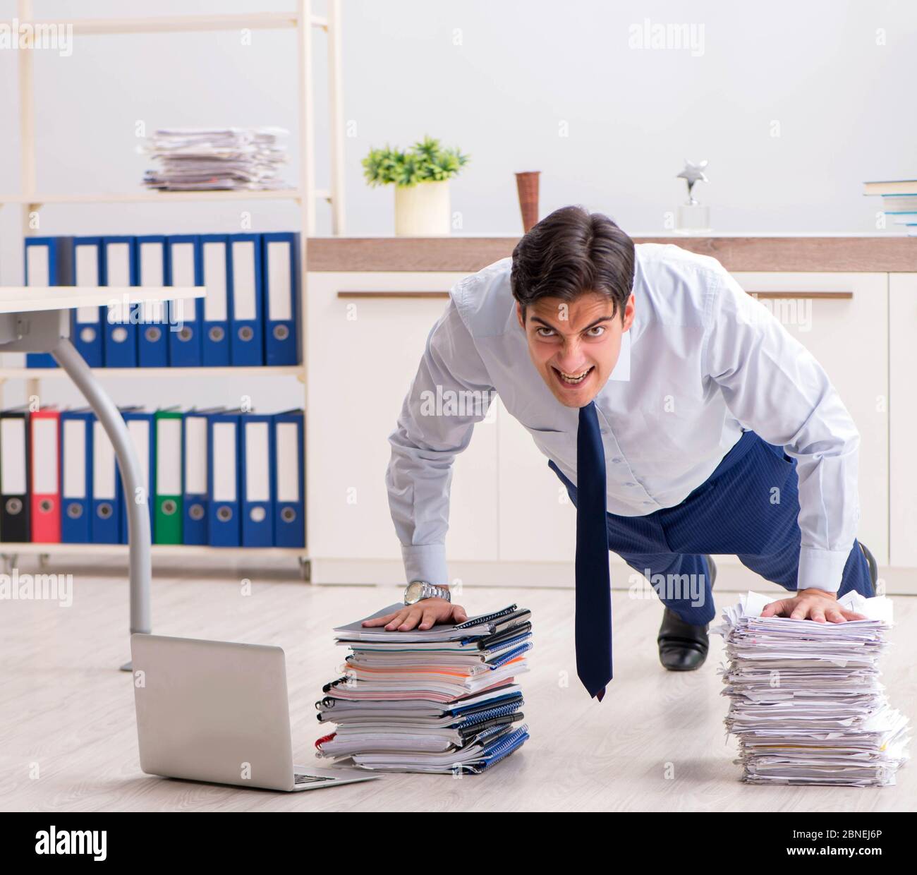 The extremely busy employee working in the office Stock Photo - Alamy