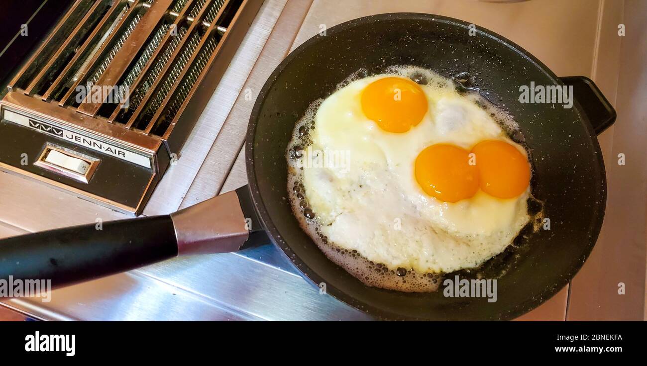 Breakfast frying on the stove including a double yolk egg Stock Photo ...