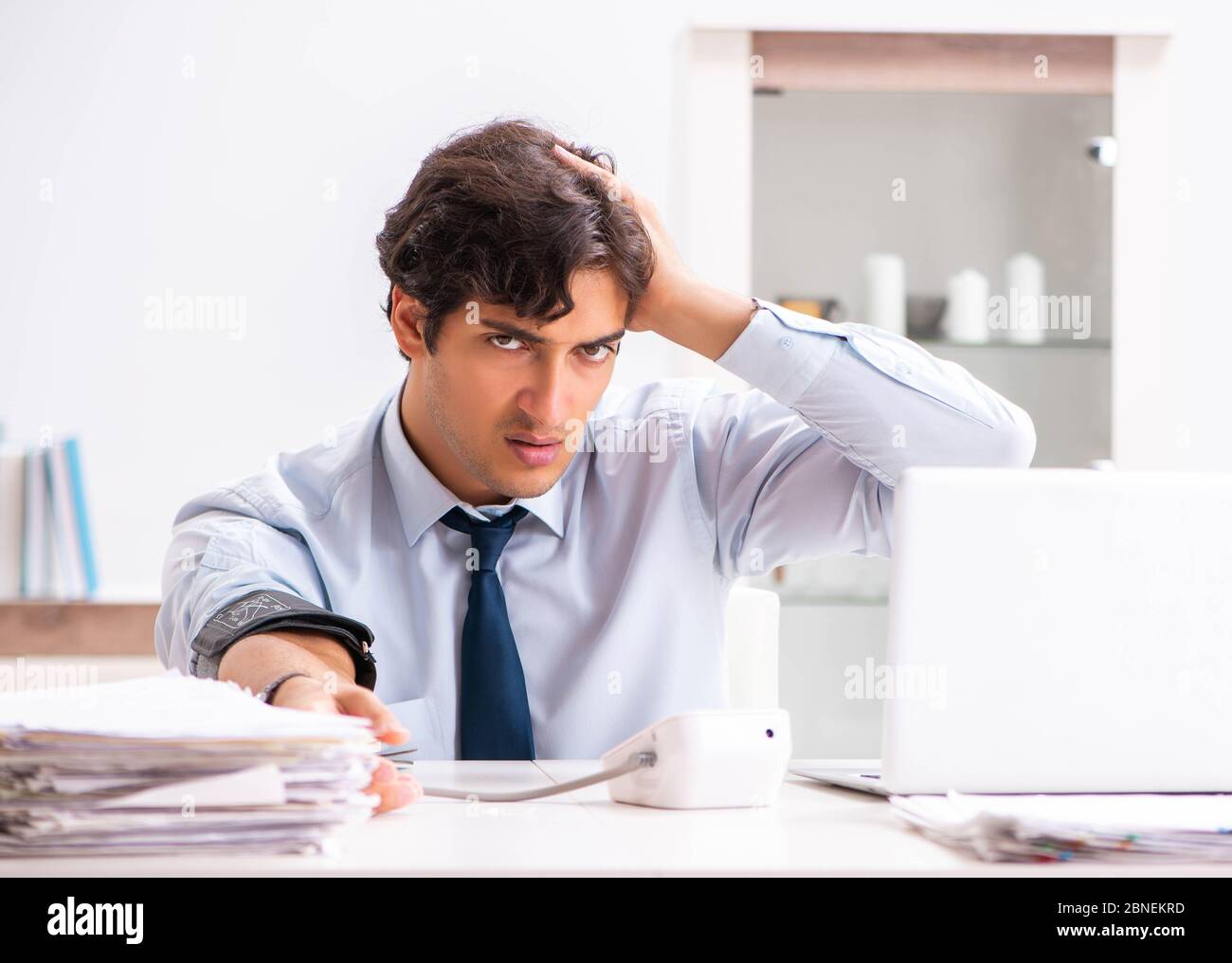 The man under stress measuring his blood pressure Stock Photo - Alamy