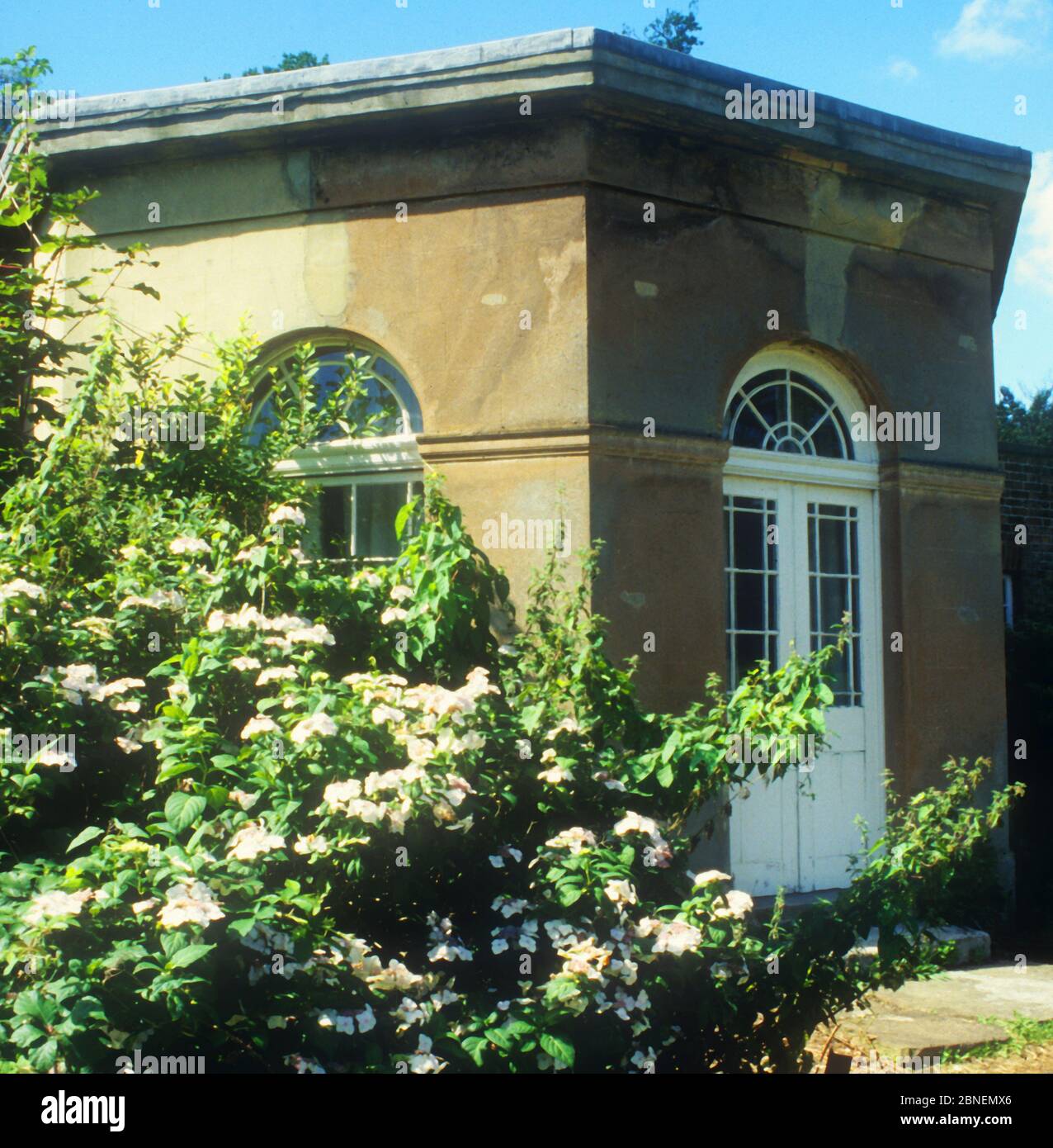 A stuccoed octagonal Summer House backs on to the low east wall of the ...