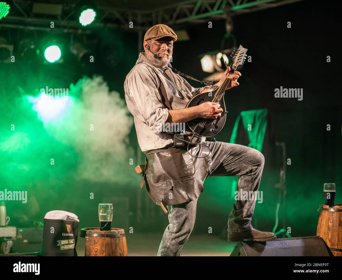 Amazing view of a funny musician giving a performance on a smoky stage ...