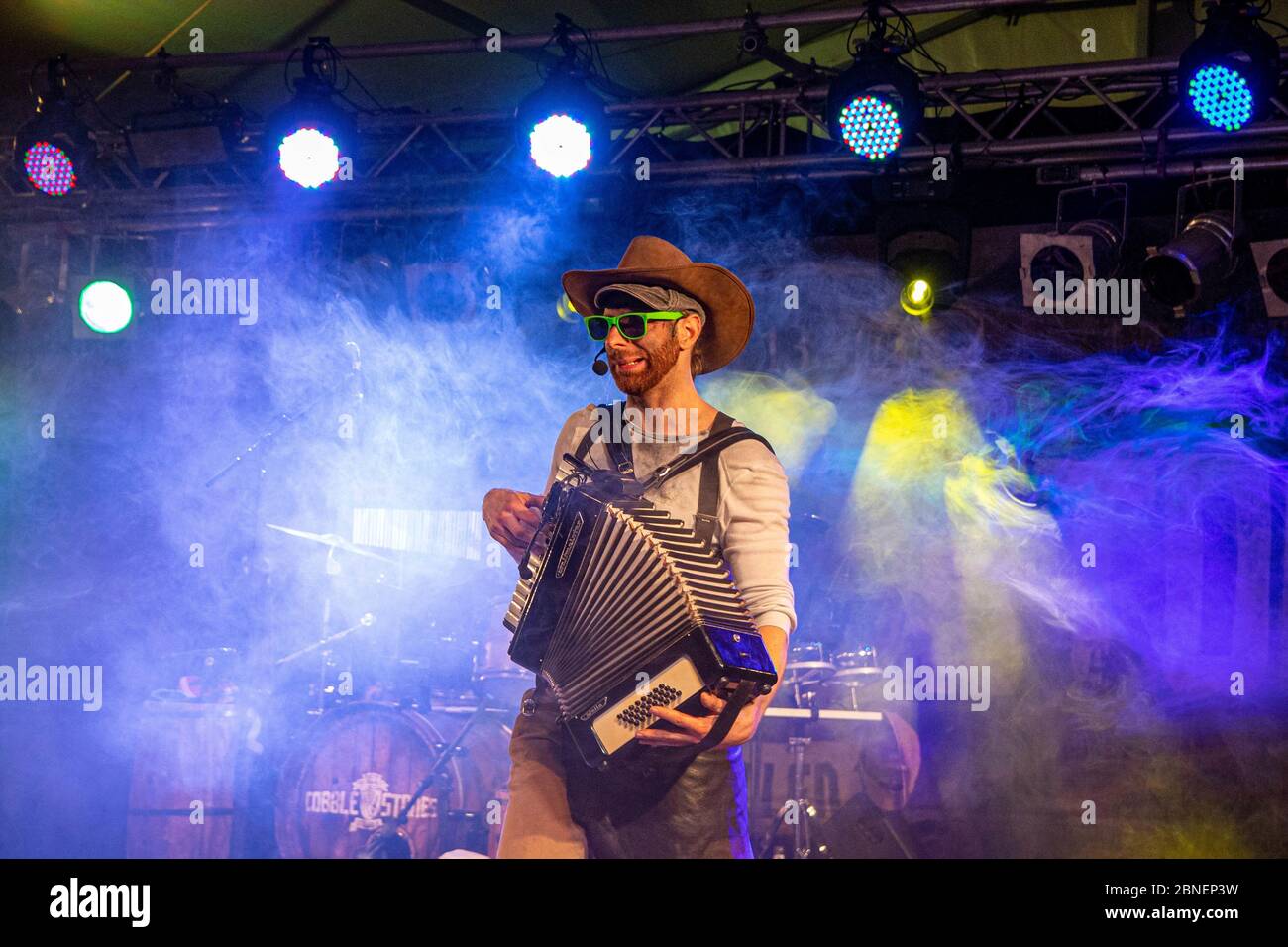 Amazing view of a funny musician giving a performance on a smoky stage ...