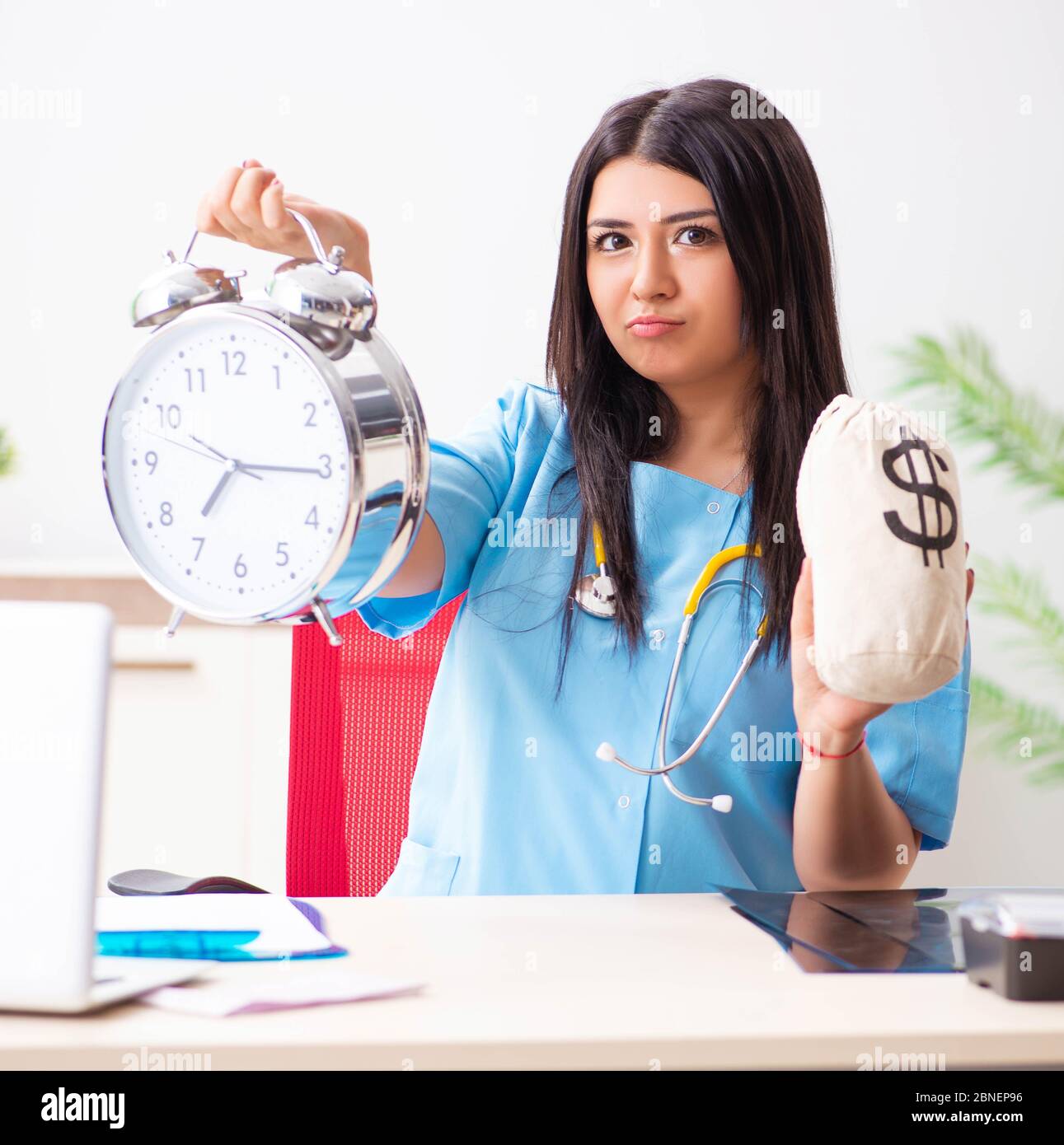 The young beautiful female doctor working in the clinic Stock Photo - Alamy