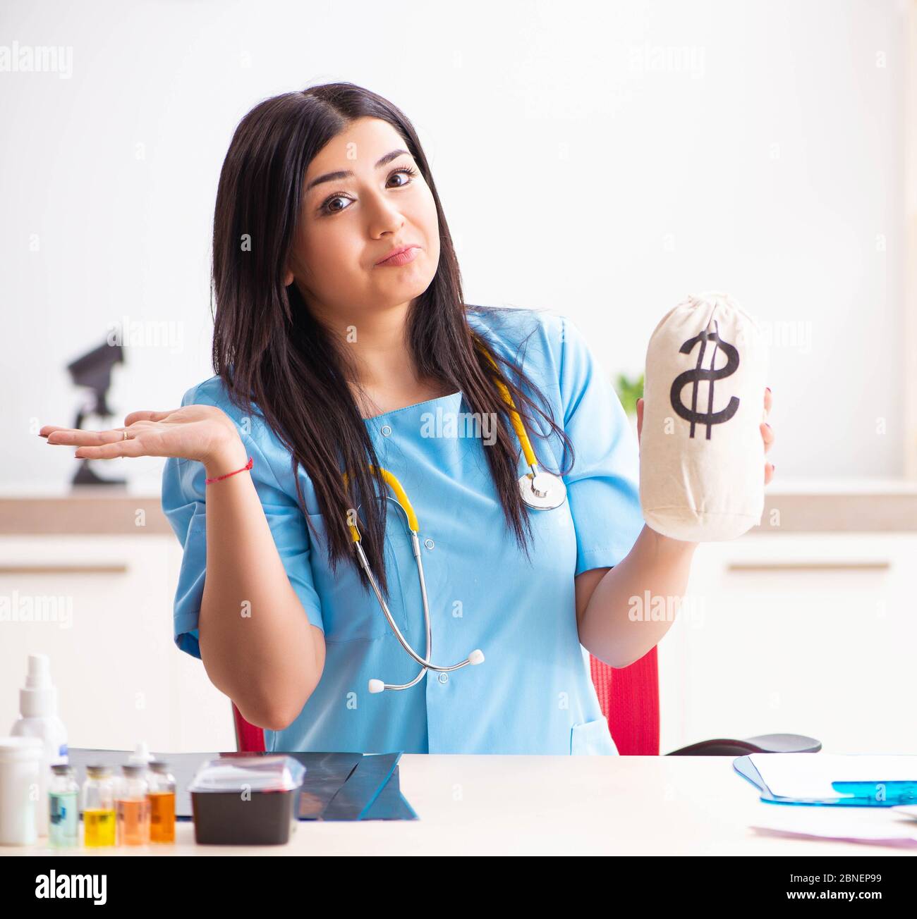The young beautiful female doctor working in the clinic Stock Photo - Alamy