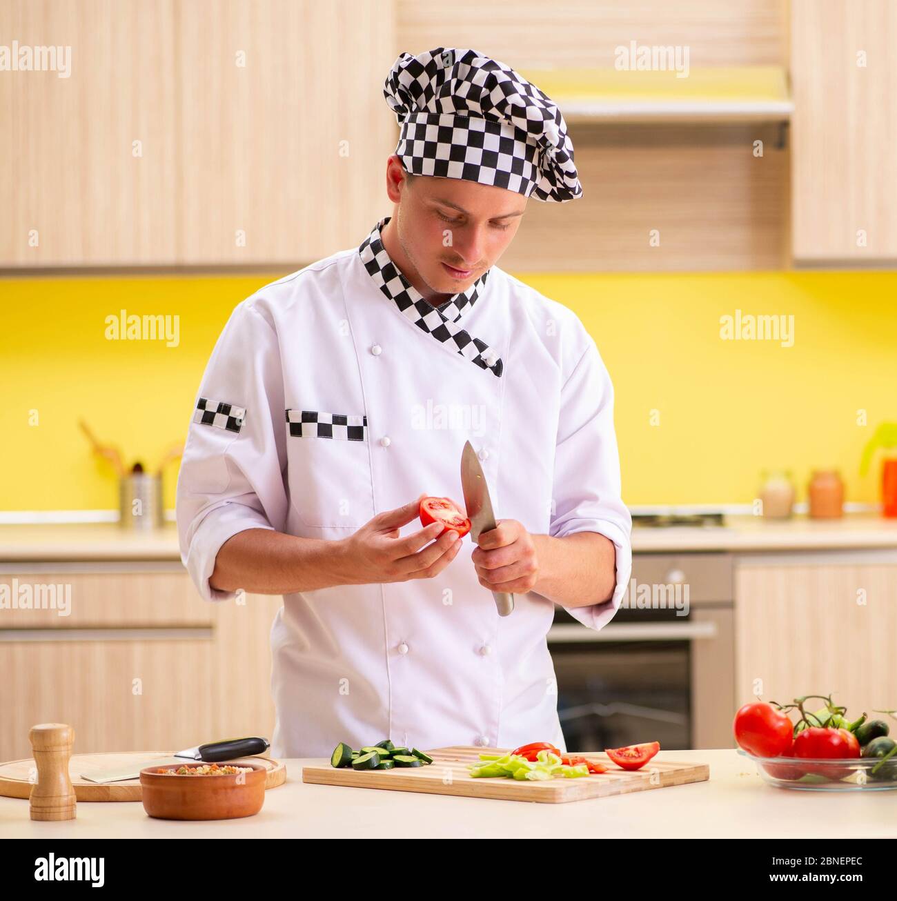 The young professional cook preparing salad at kitchen Stock Photo - Alamy