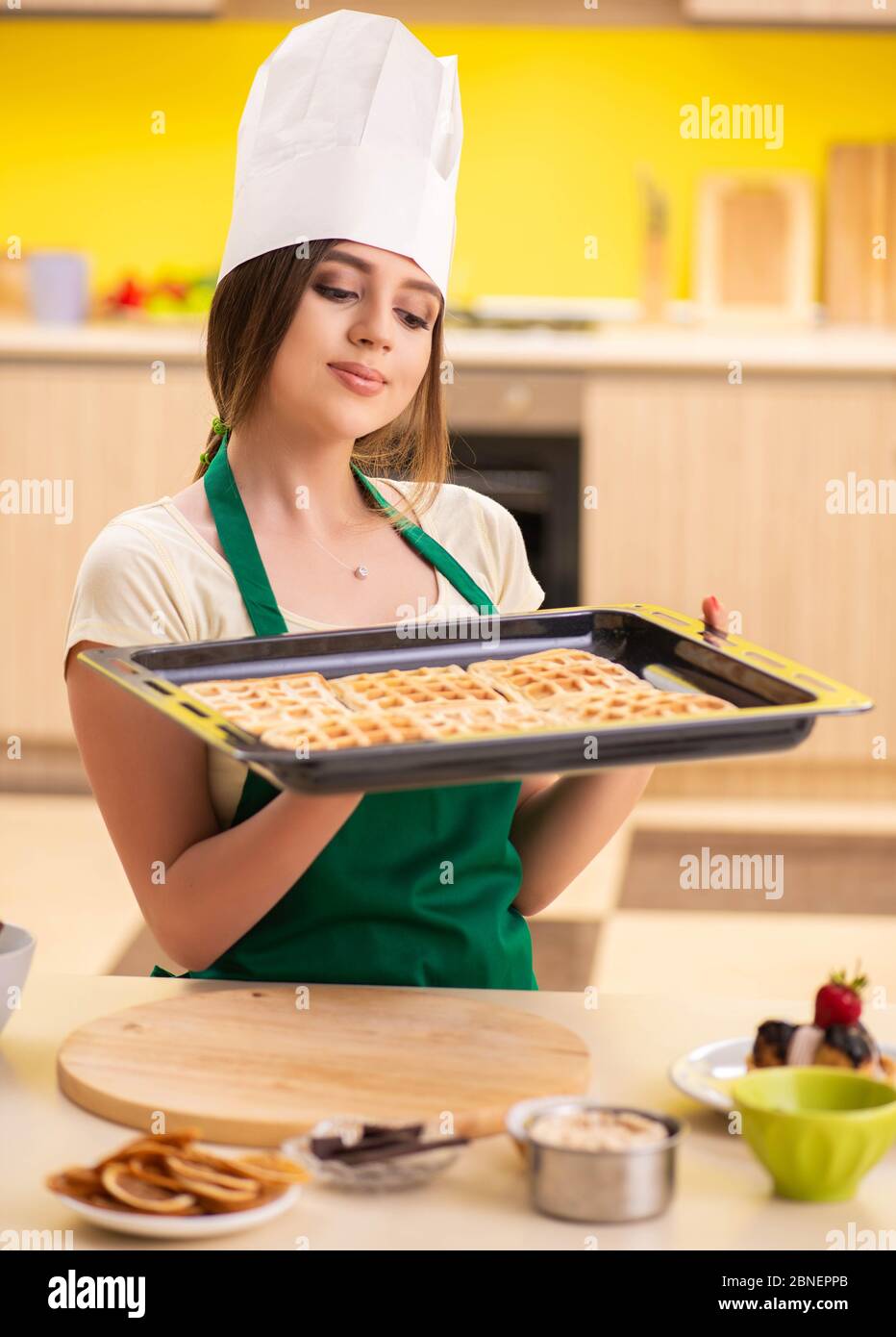 The young cook cooking cakes in the kitchen Stock Photo - Alamy