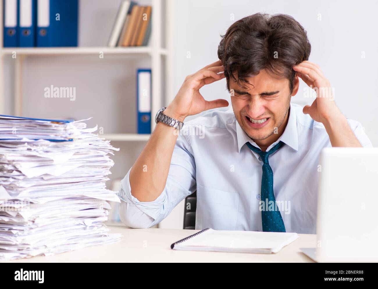 The overloaded busy employee with too much work and paperwork Stock ...