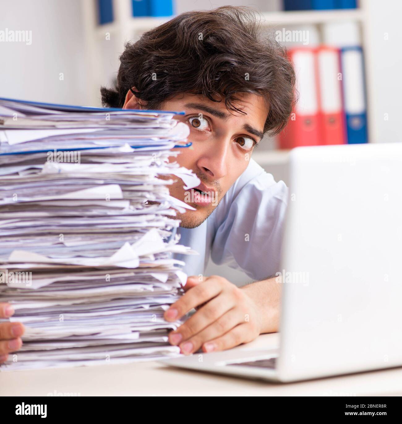 The overloaded busy employee with too much work and paperwork Stock ...