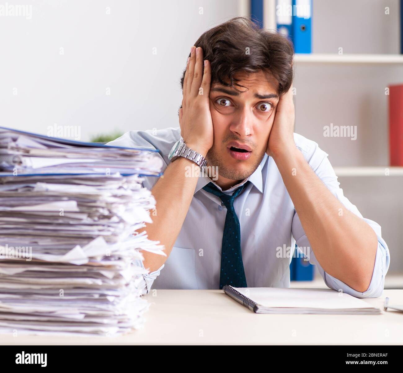 The overloaded busy employee with too much work and paperwork Stock ...