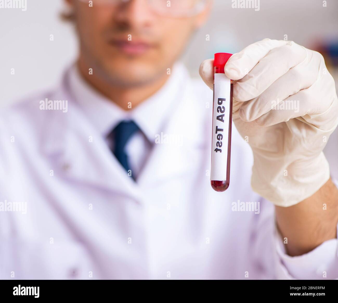 The young handsome lab assistant testing blood samples in hospital ...