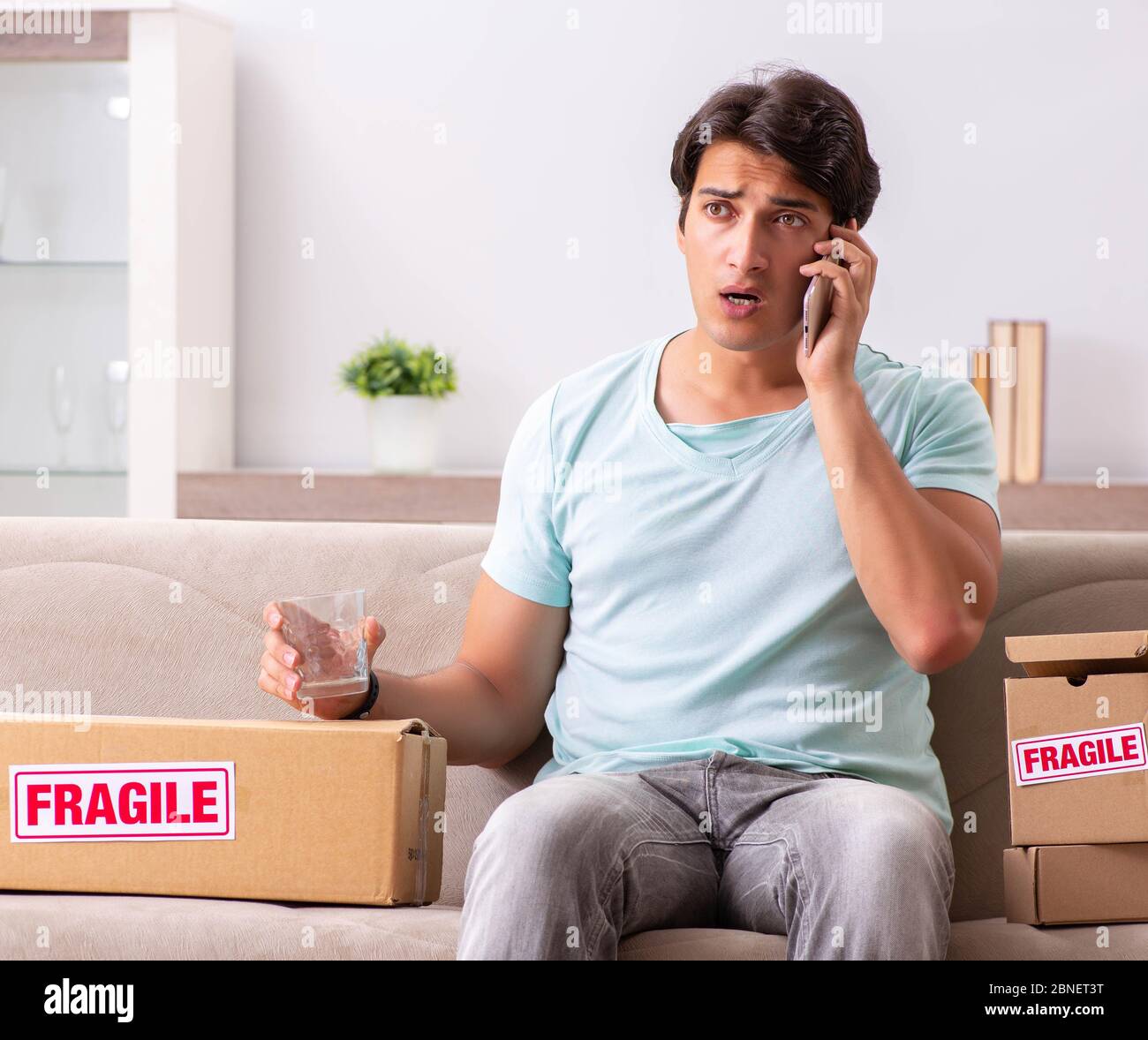 The man opening fragile parcel ordered from internet Stock Photo - Alamy