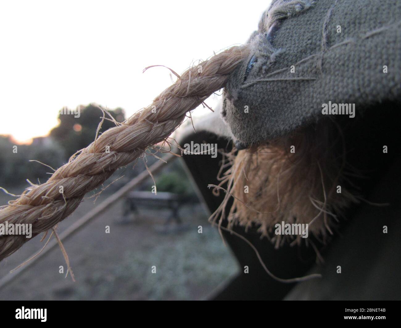 Closeup of a hemp rope tightening the side of a ridge tent and flysheet ...