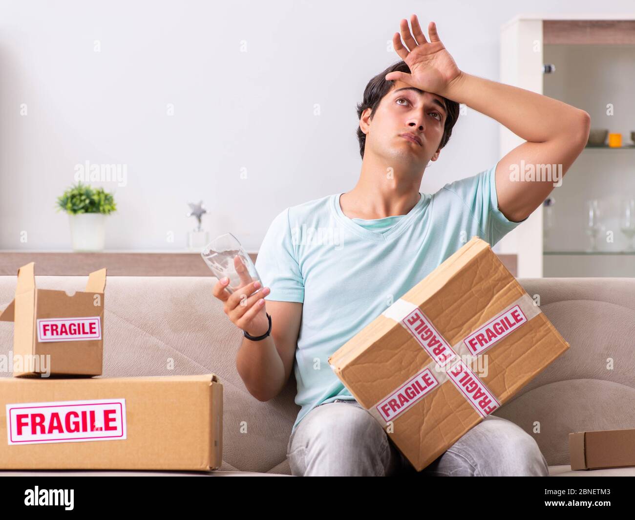 The man opening fragile parcel ordered from internet Stock Photo - Alamy