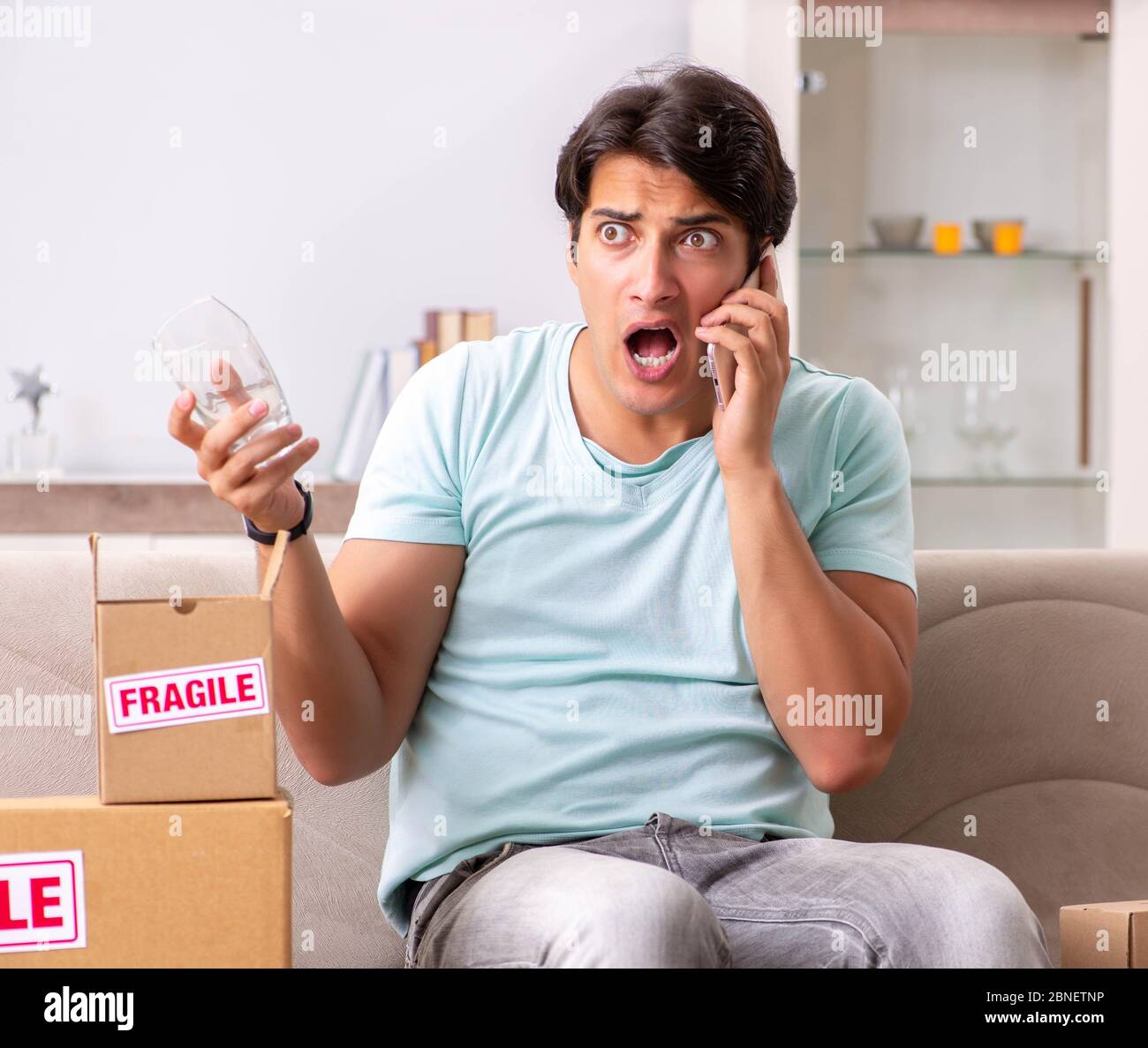 The man opening fragile parcel ordered from internet Stock Photo - Alamy