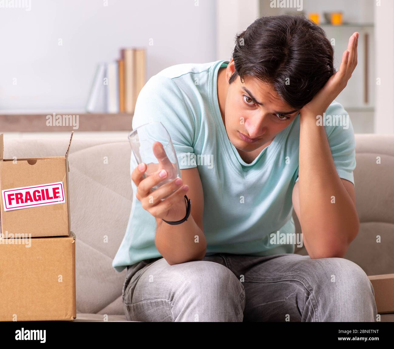 The man opening fragile parcel ordered from internet Stock Photo - Alamy