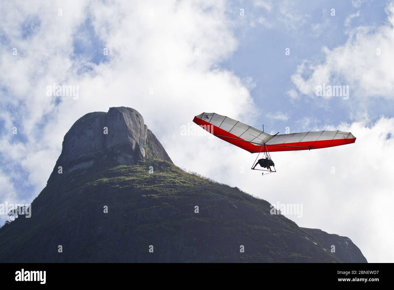 Amazing shot of human flying on a hang glider Stock Photo - Alamy