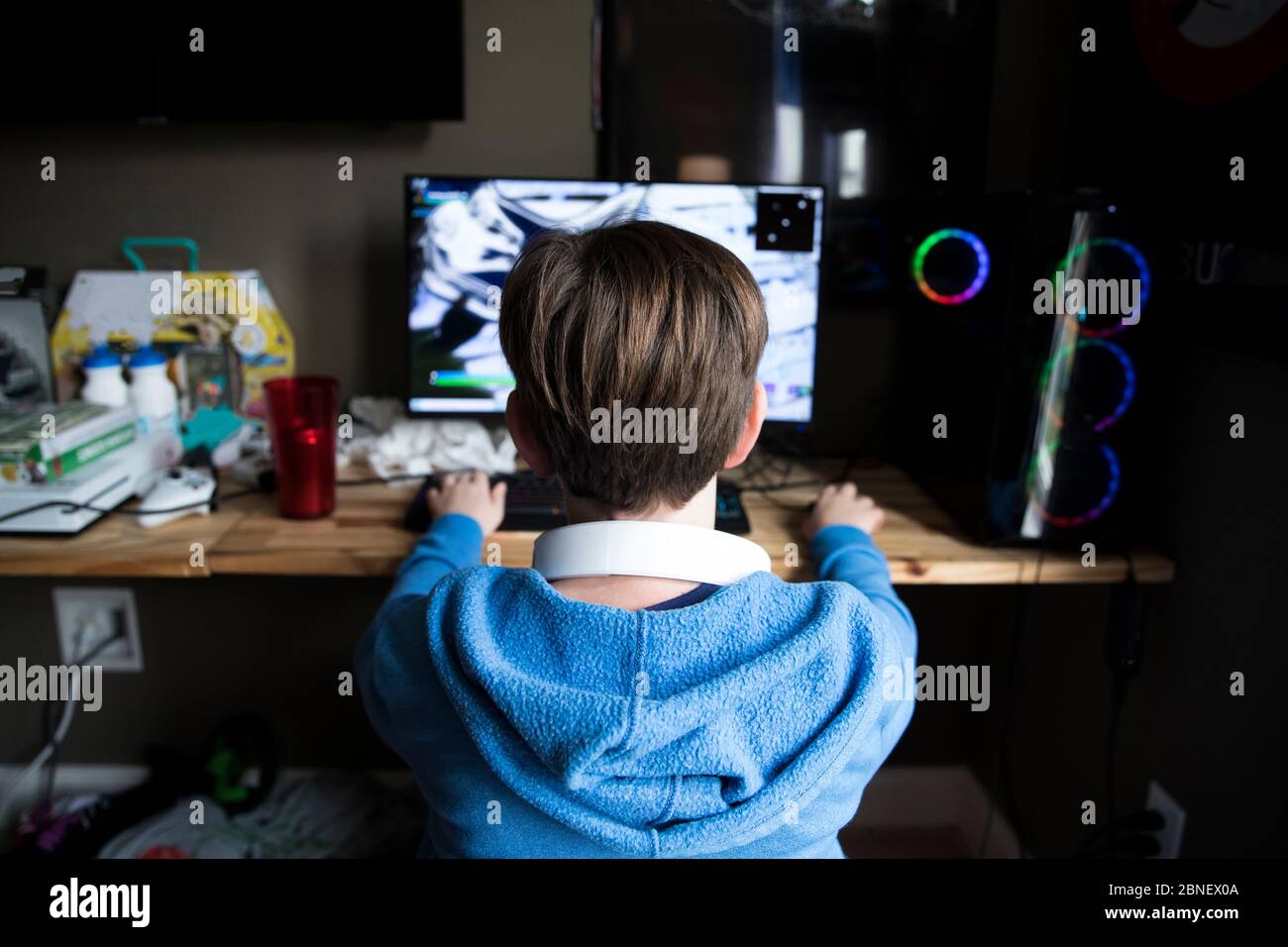 Rear View of Teen Boy Playing Gaming Computer on a Messy Desk Stock ...