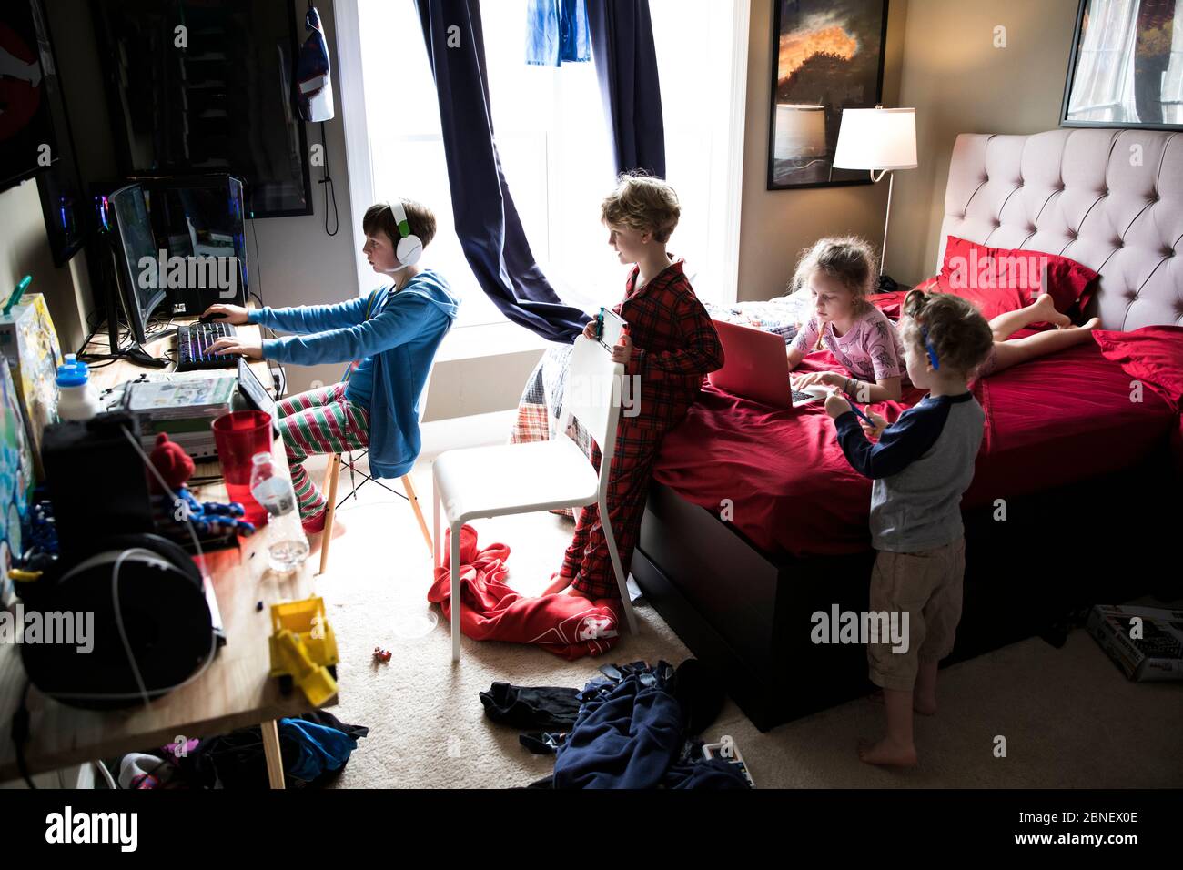 Four Siblings Hanging Out in Messy Teenage Brothers Bedroom Stock Photo ...
