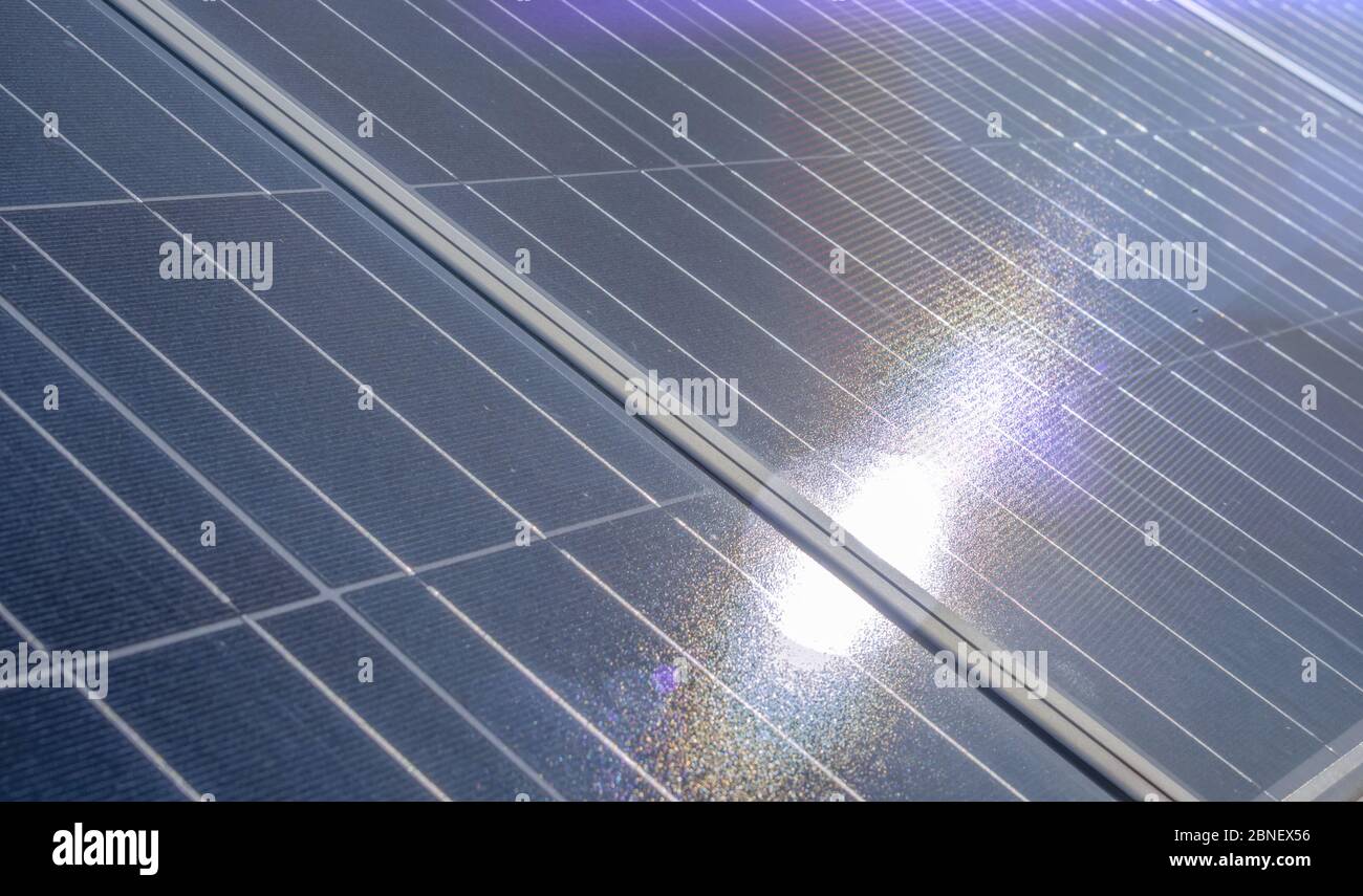 Sun shining over the blue solar panel Stock Photo - Alamy