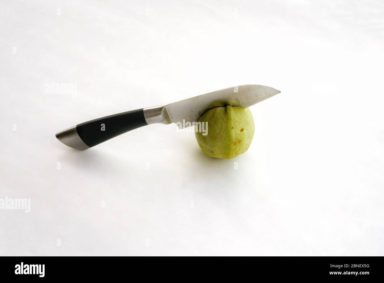 Amazing shot of a knife embedded in a fruit Stock Photo - Alamy