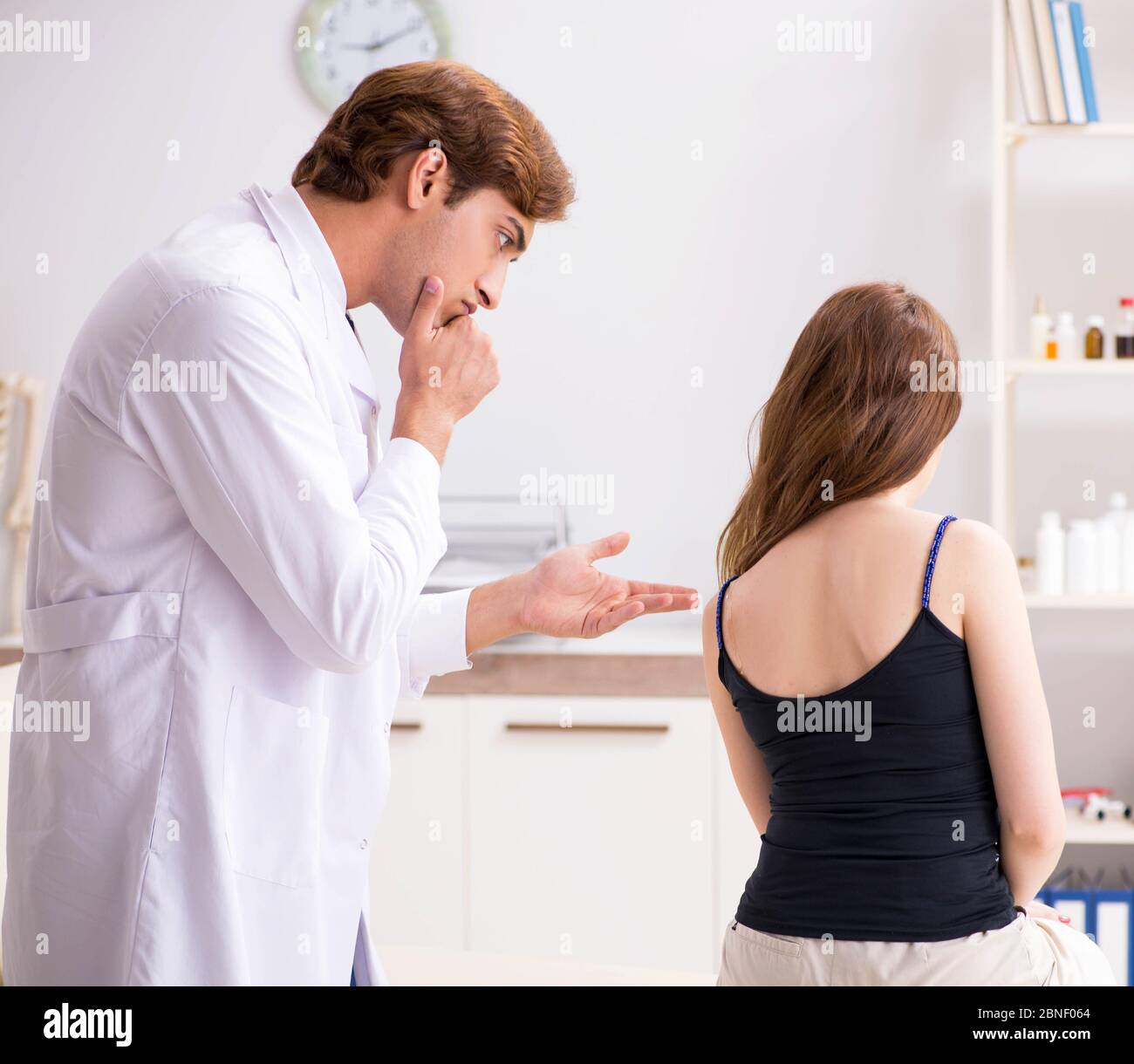The female patient visiting young handsome doctor chiropractor Stock ...