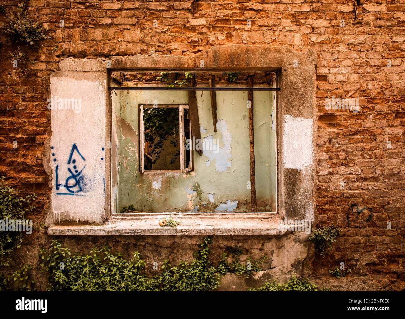 full framed ramshackle window with another window in it, from abandoned ...