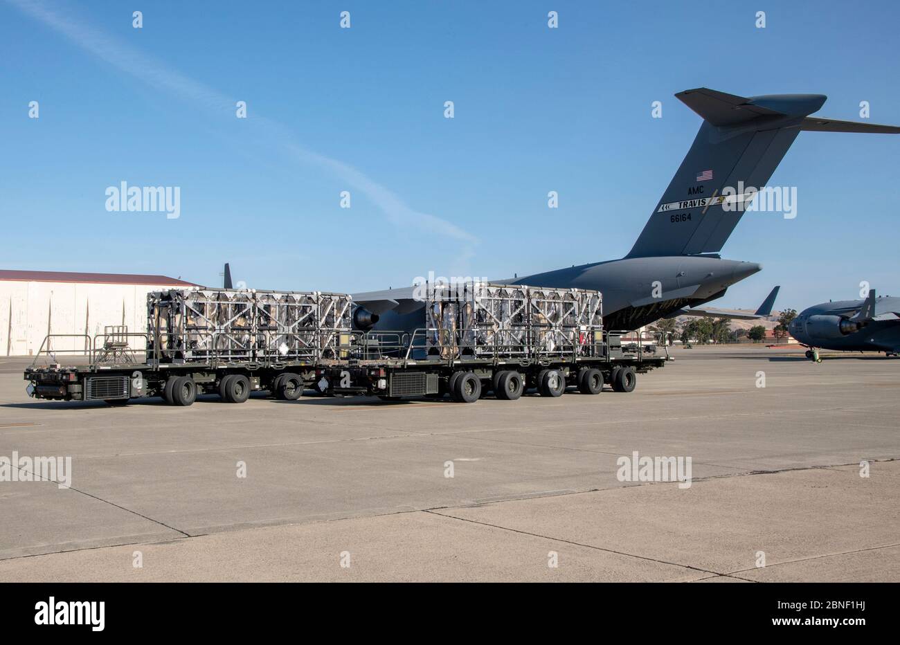 Two Transport Isolation System capsules sit on Tunner 60K loaders prior ...