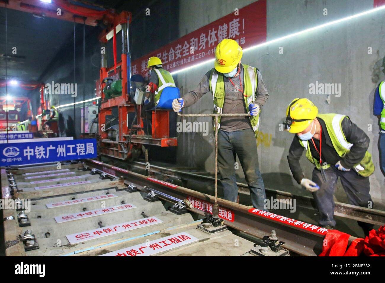 Construction workers hold a simple ceremony to celebrate the finish of ...
