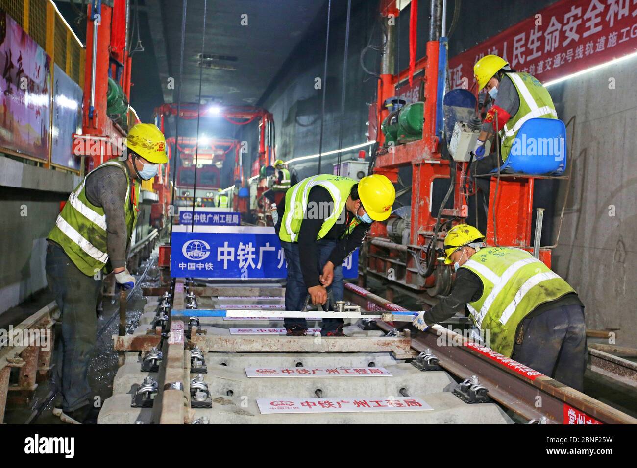 Construction workers hold a simple ceremony to celebrate the finish of ...