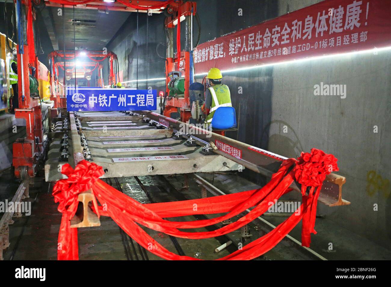 Construction workers hold a simple ceremony to celebrate the finish of ...