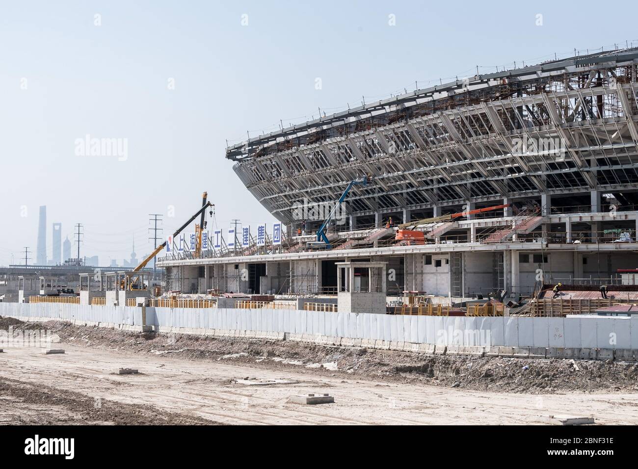 Workers are busy at constructing the Pudong Football Stadium, which ...