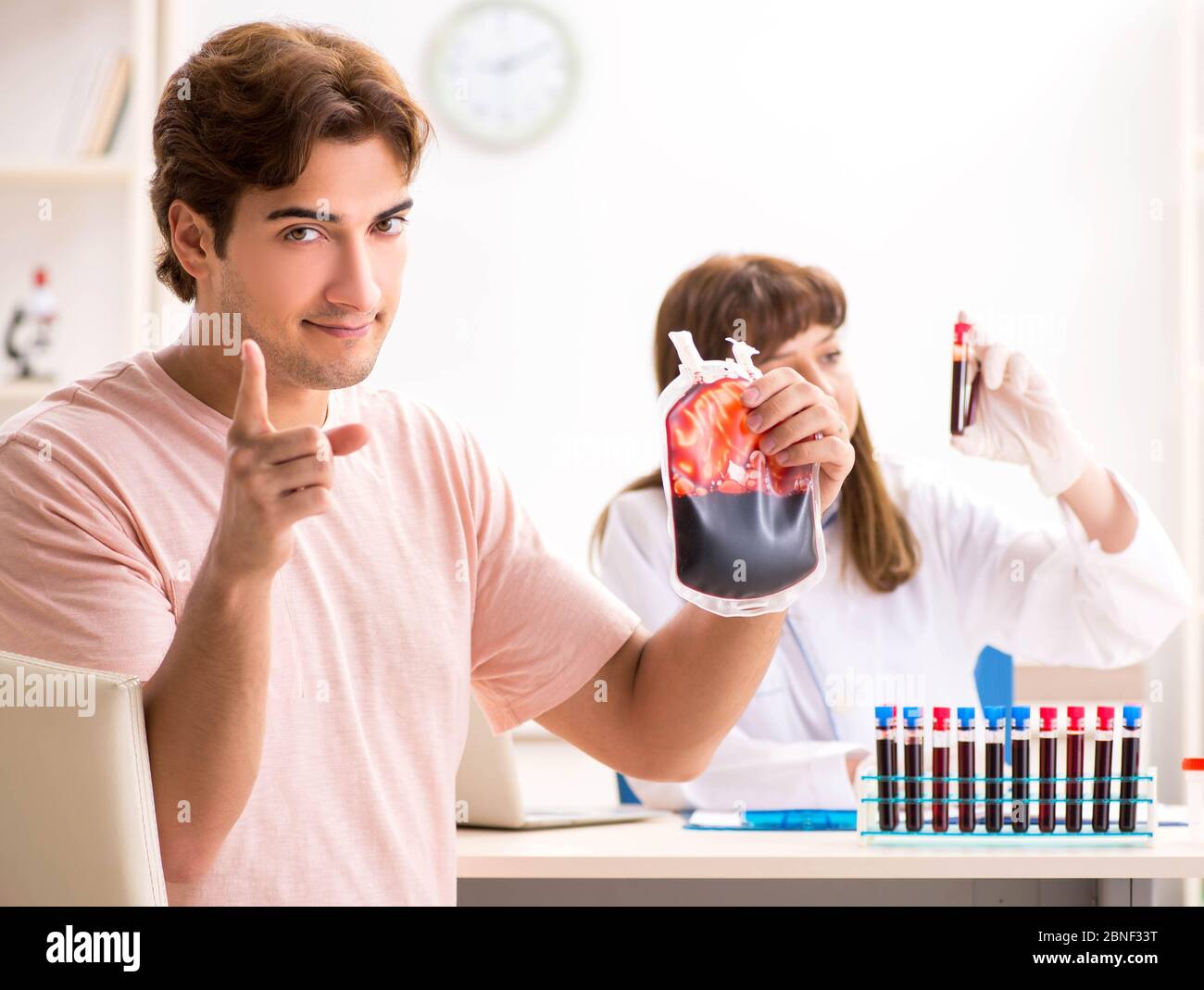 The man giving his blood as a donor Stock Photo - Alamy