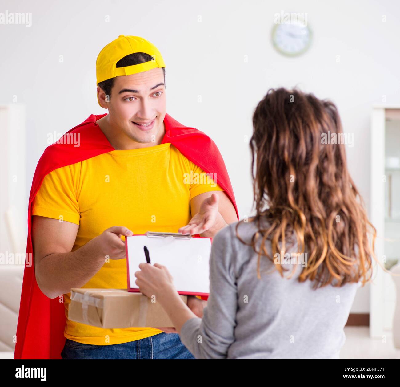 The superhero delivery guy with box Stock Photo - Alamy