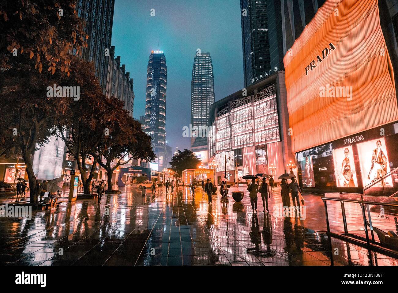 --FILE--Pedestrians walk along the street with local skyscrapers as ...