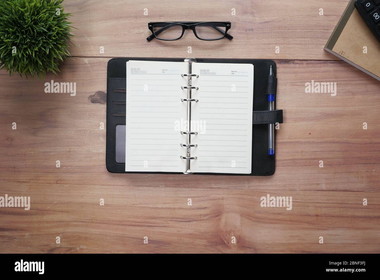 Top view of notepad and a pen on wooden table Stock Photo - Alamy
