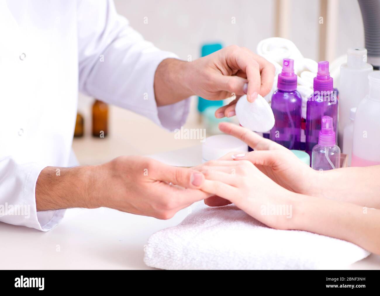 The hands during manicure care session Stock Photo - Alamy