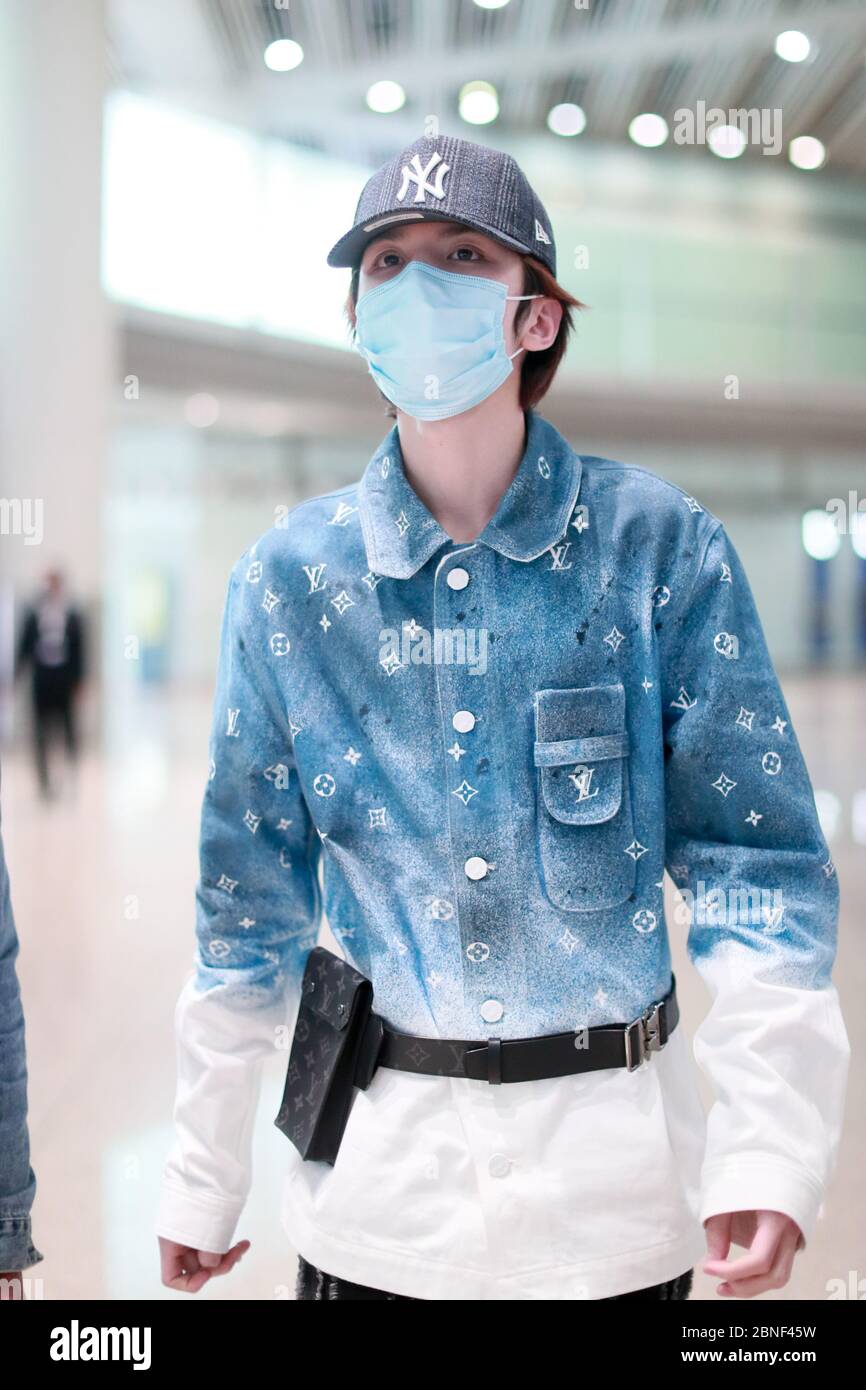 Chinese singer Ling Chao arrives at a Beijing airport before departure ...