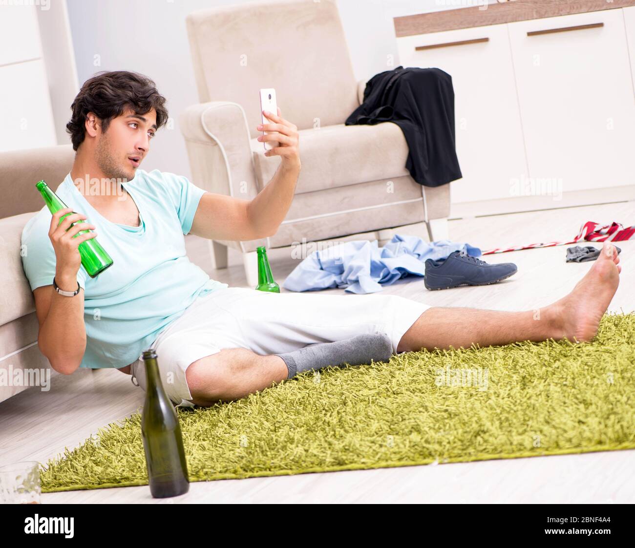 The young drunk handsome man after party at home Stock Photo - Alamy