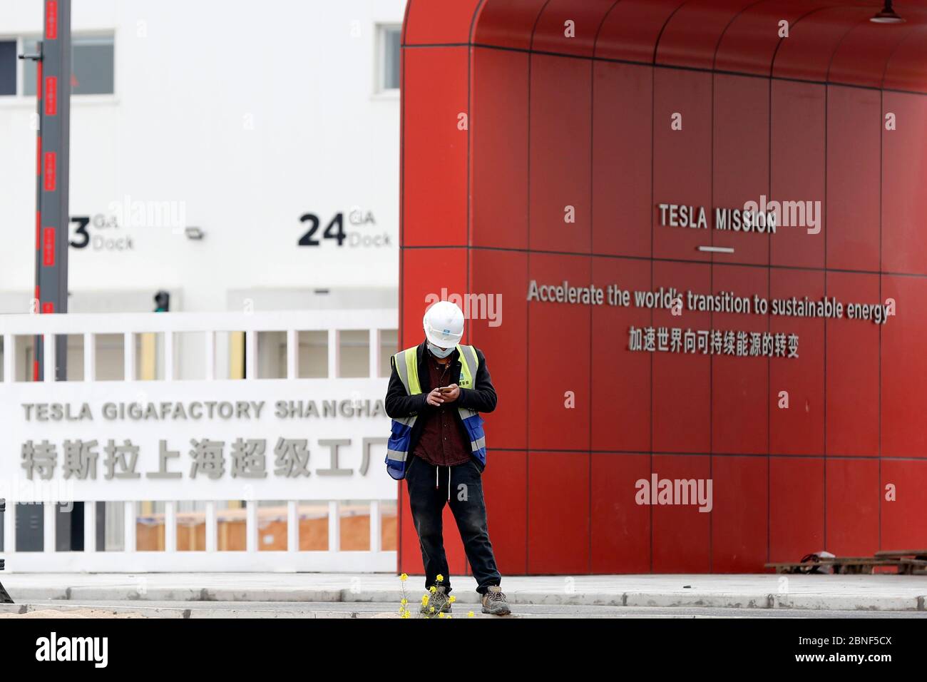 A security guard stands in front of the Tesla Gigafactory 3, which ...