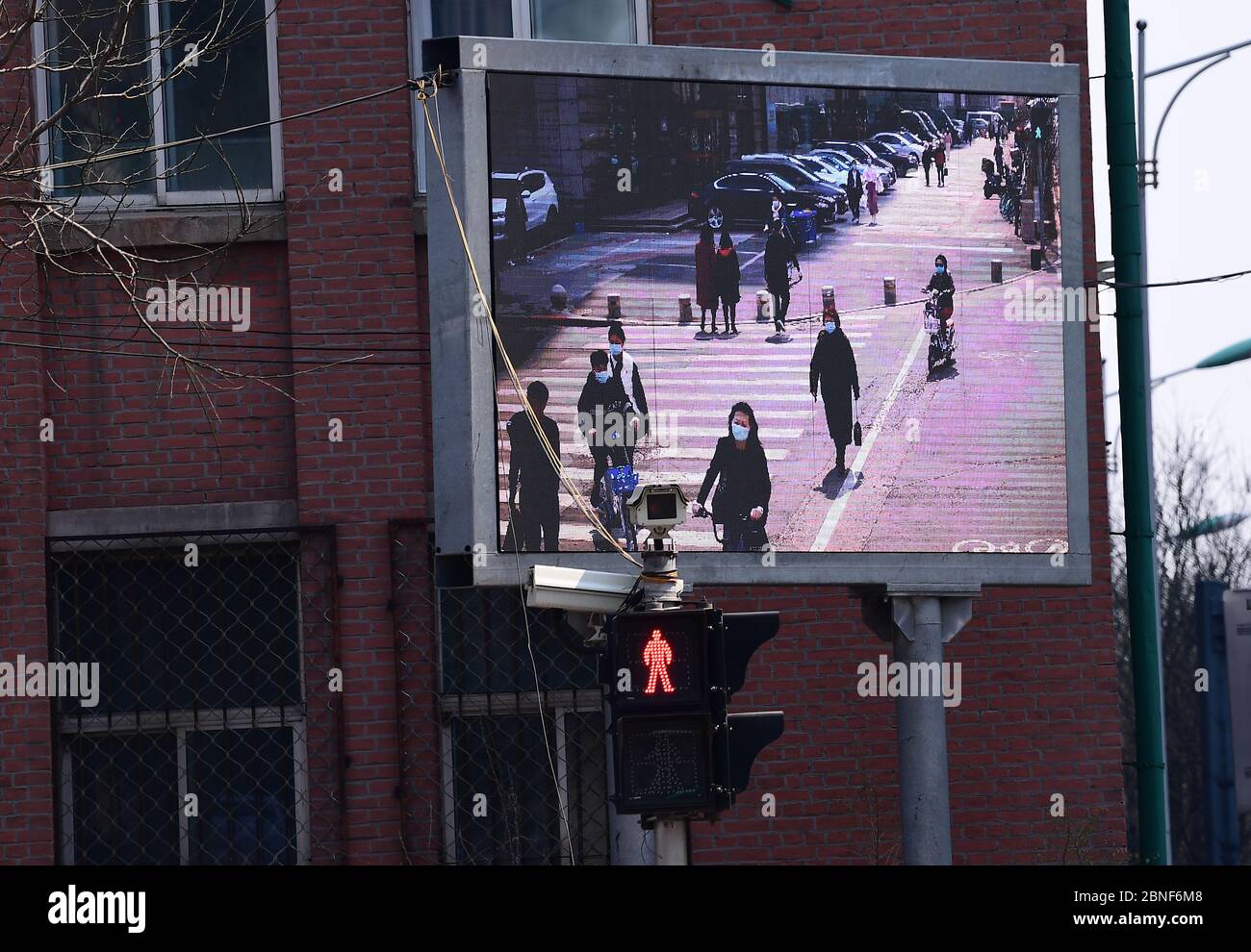 A large screen is deployed near crosswalk to show videos in which ...