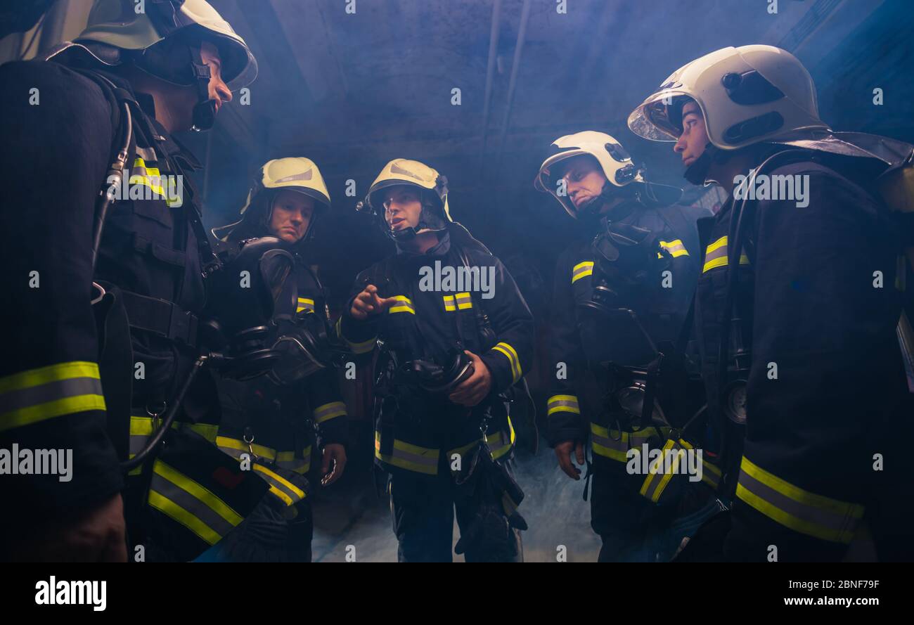 Group of firemen in the fire department organizing action plan for safe ...