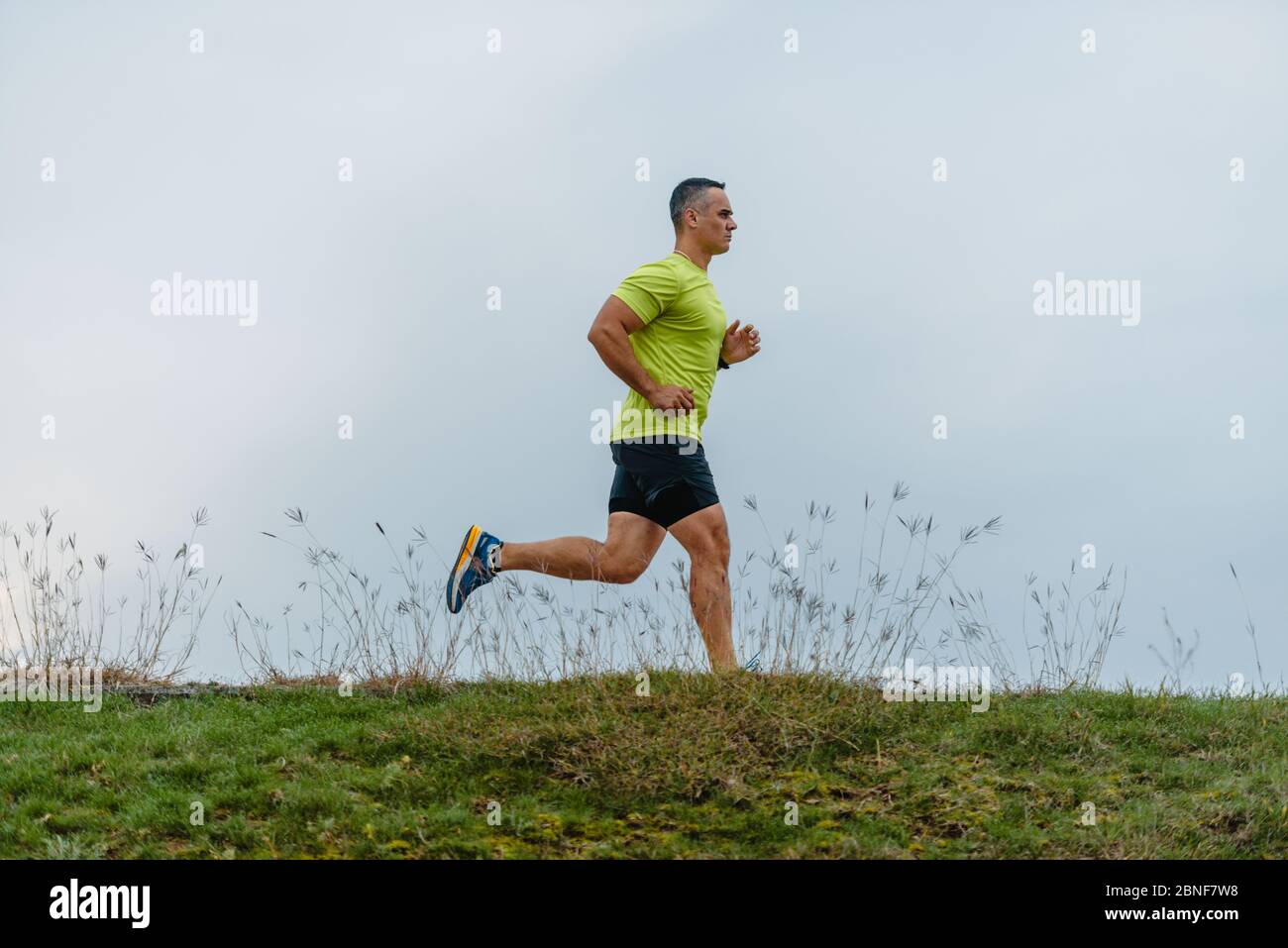 Well built man over 40 wearing activewear training gear running Stock ...