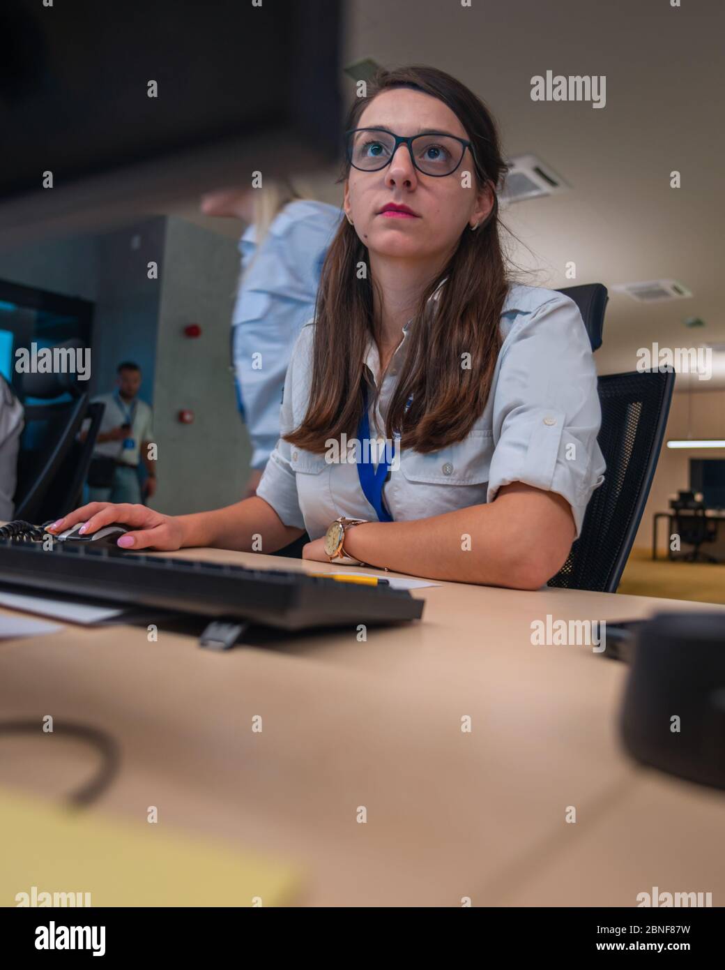Female security guards working on computers while sitting in the main ...