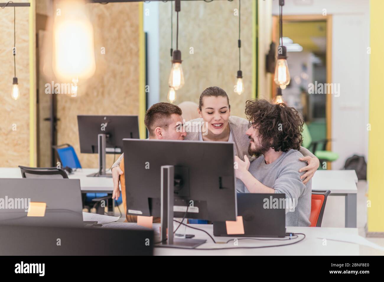 Group of coworkers, colleagues having fun at the office while chatting ...