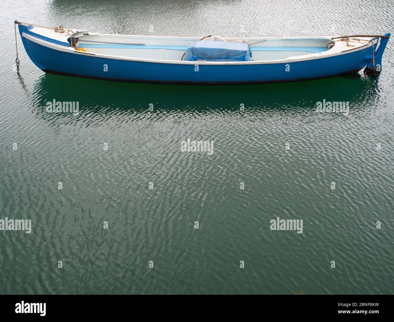 Blue Canoe In Rippled Water Stock Photo - Alamy