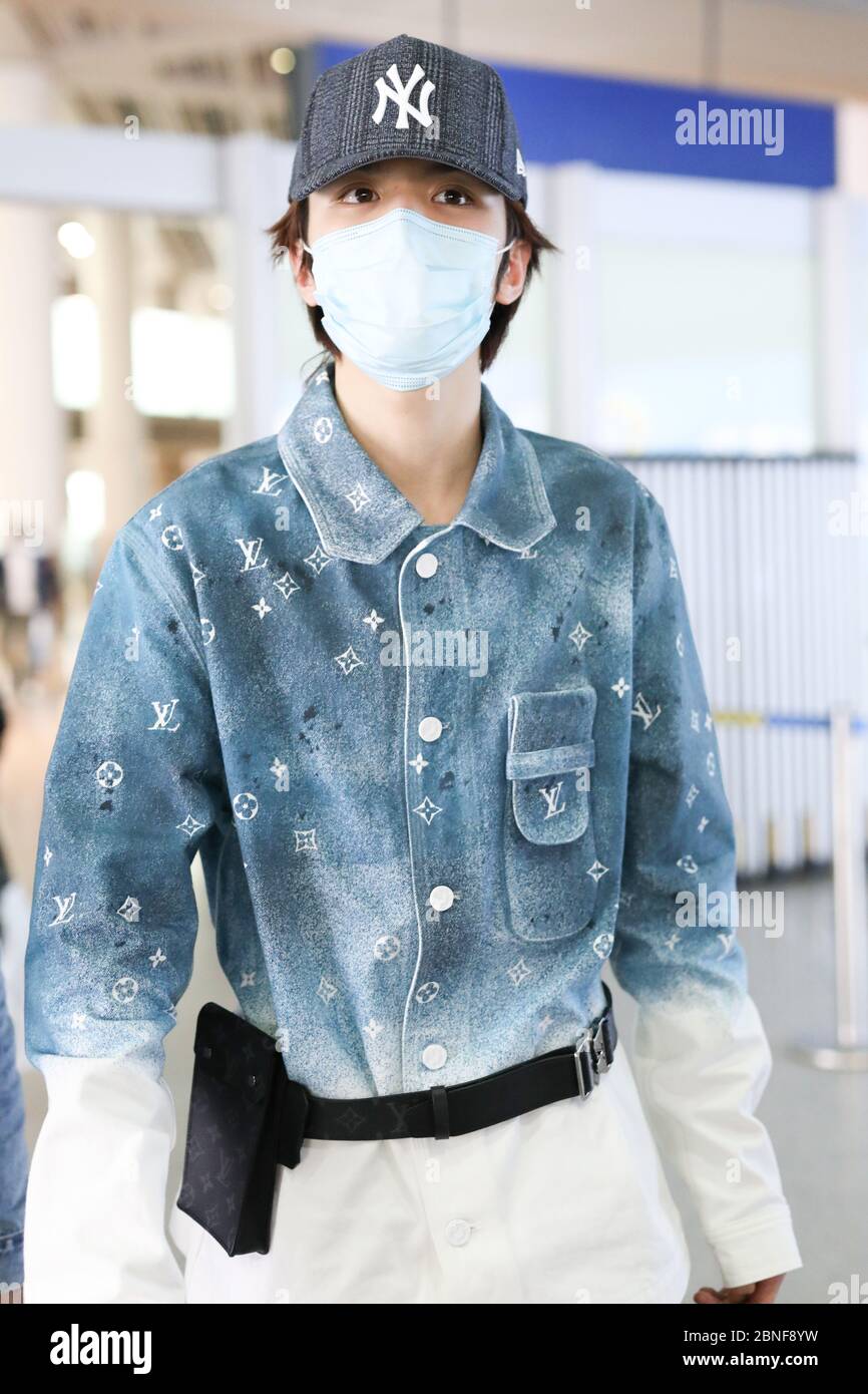 Chinese singer Ling Chao arrives at a Beijing airport before departure ...