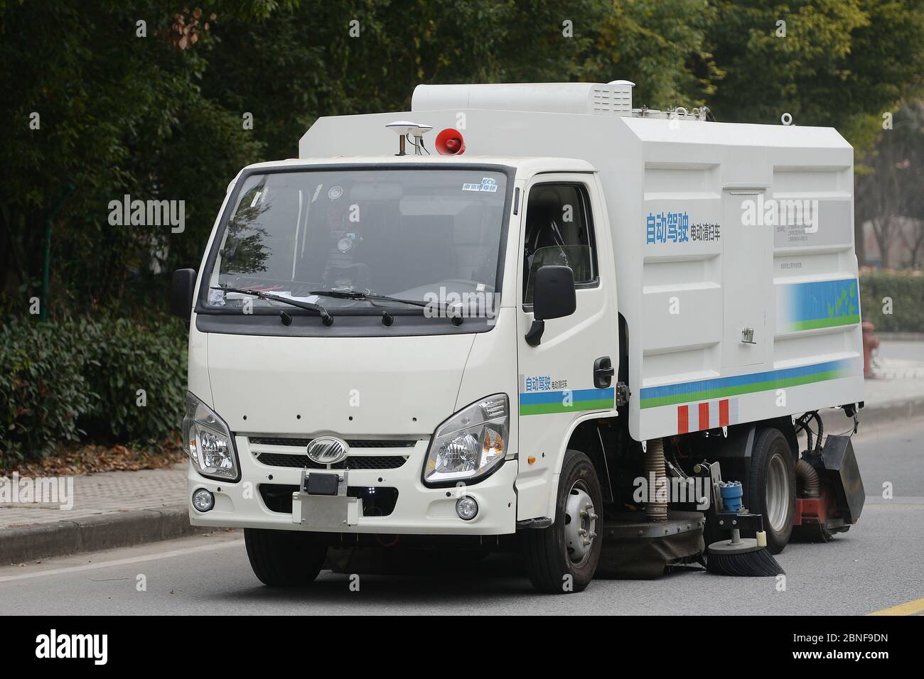 Faculty of Tongji University test an unmanned cleaning truck at a on ...