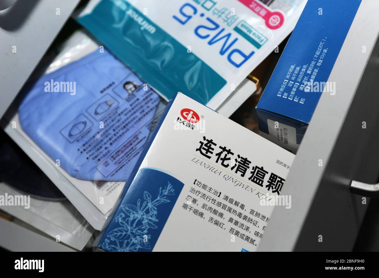 --FILE--A box of Lianhua Qingwen granule is placed with mask on a table ...