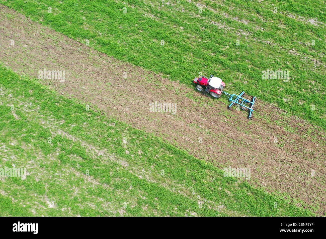 An aerial view of agricultural machines taking the chance of spring ...