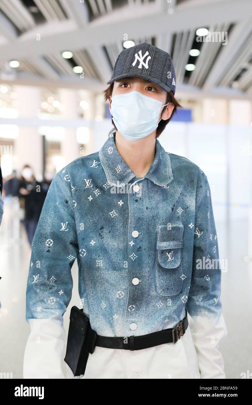 Chinese singer Ling Chao arrives at a Beijing airport before departure ...